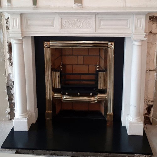 white staturay marble fireplace mantel with doric column